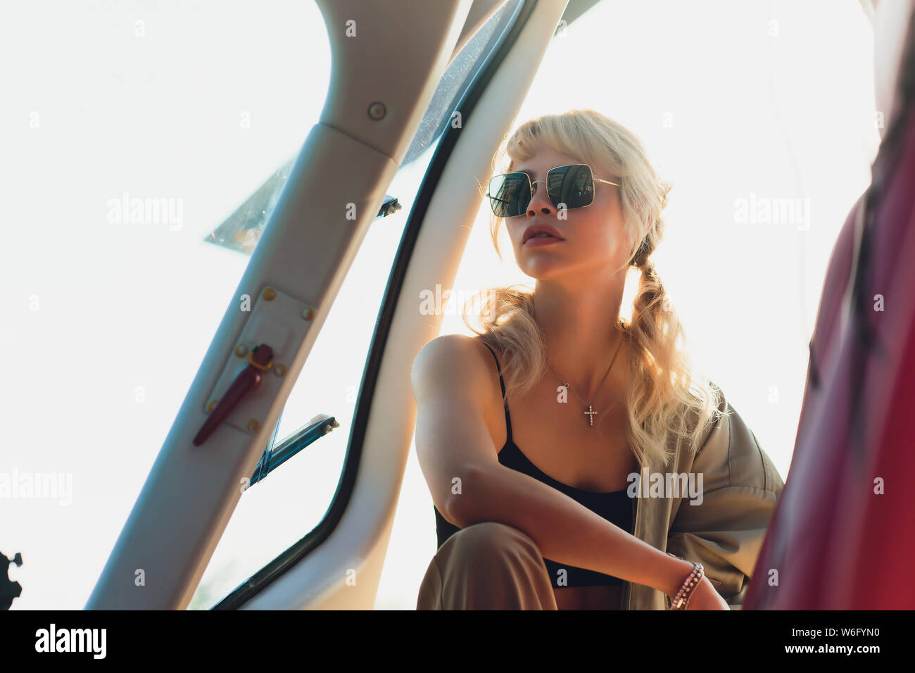 Female pilot in cockpit of helicopter before take off. Young woman helicopter pilot Stock Photo ...
