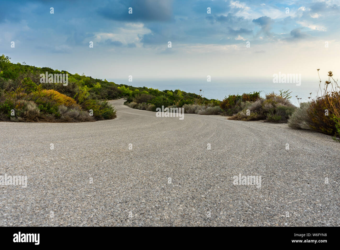 Curved road with ocean water landscape view Stock Photo - Alamy