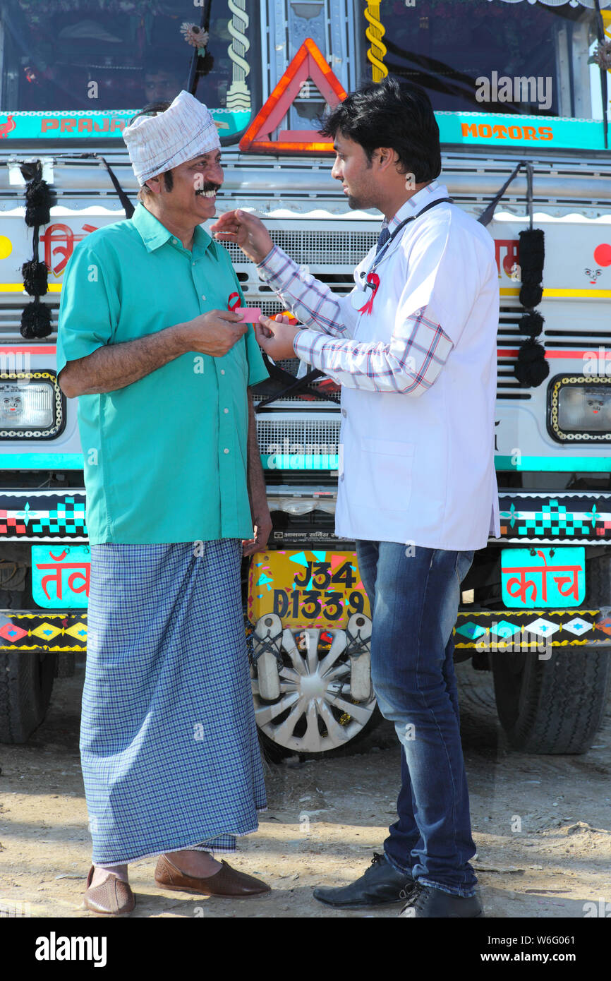 Male doctor giving condom to a truck driver Stock Photo - Alamy
