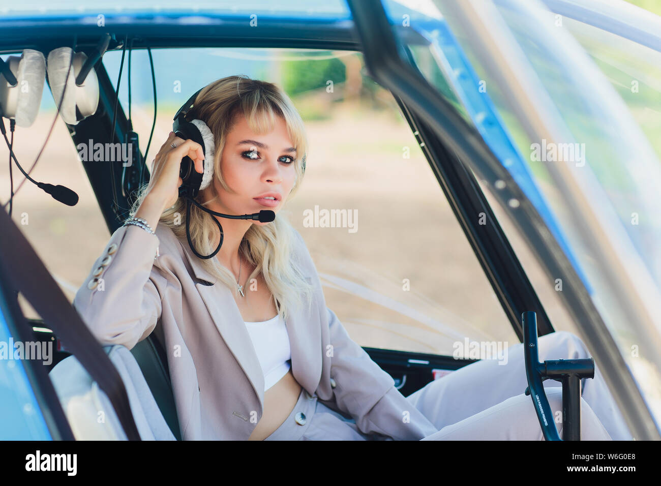 Female pilot in cockpit of helicopter before take off. Young woman helicopter pilot Stock Photo ...
