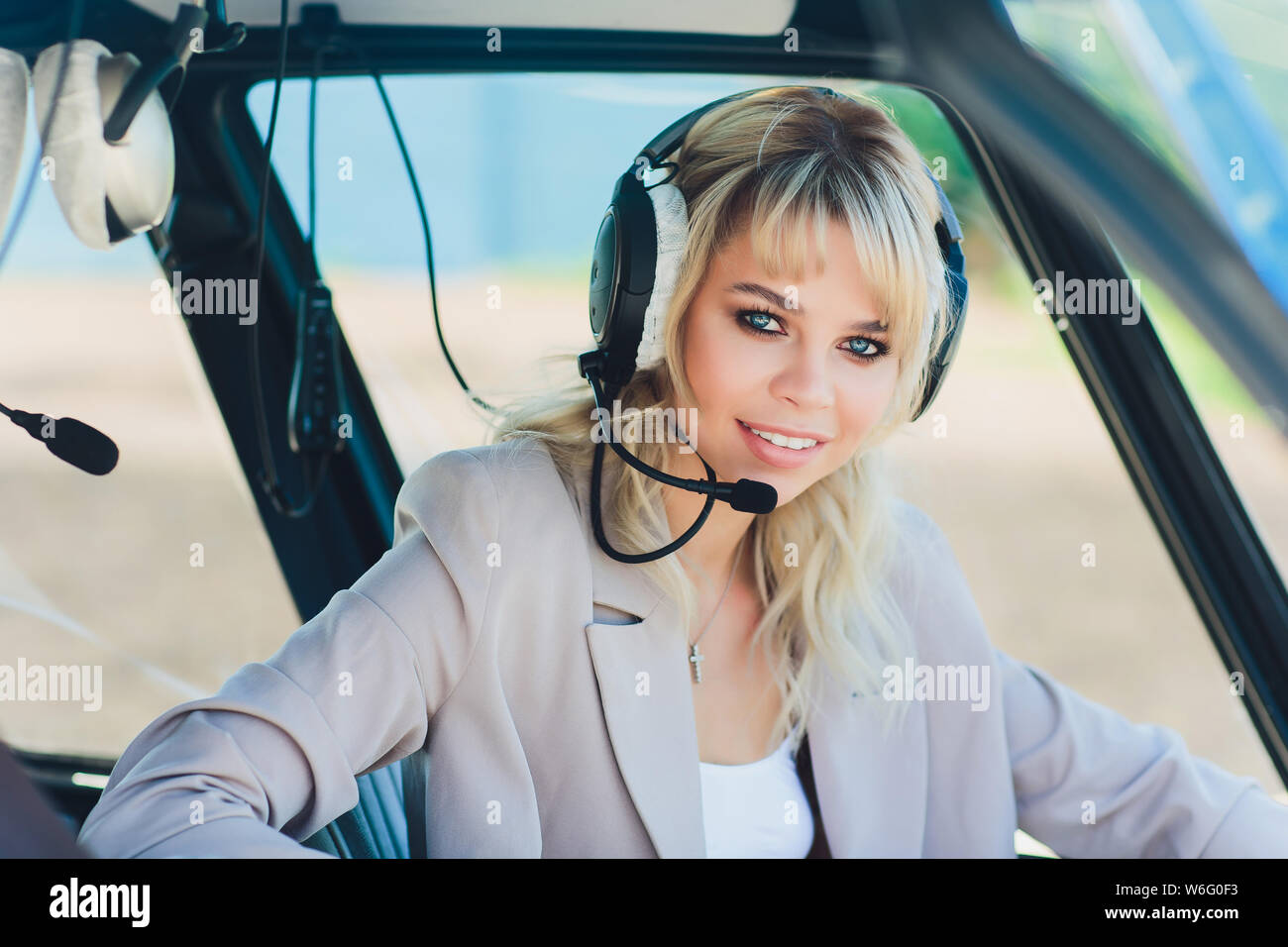 Female pilot in cockpit of helicopter before take off. Young woman helicopter pilot Stock Photo ...