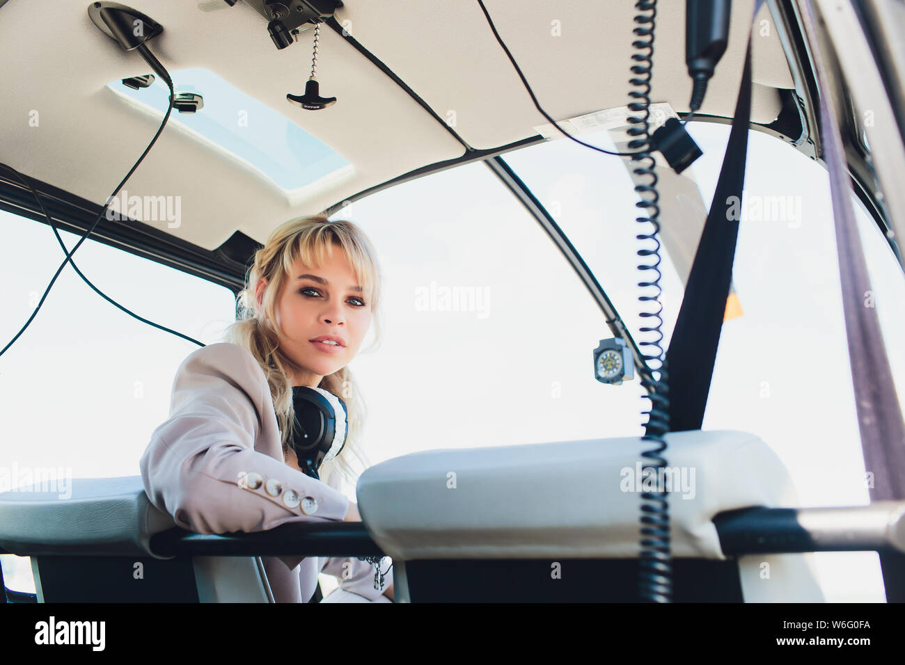 Female pilot in cockpit of helicopter before take off. Young woman helicopter pilot Stock Photo ...