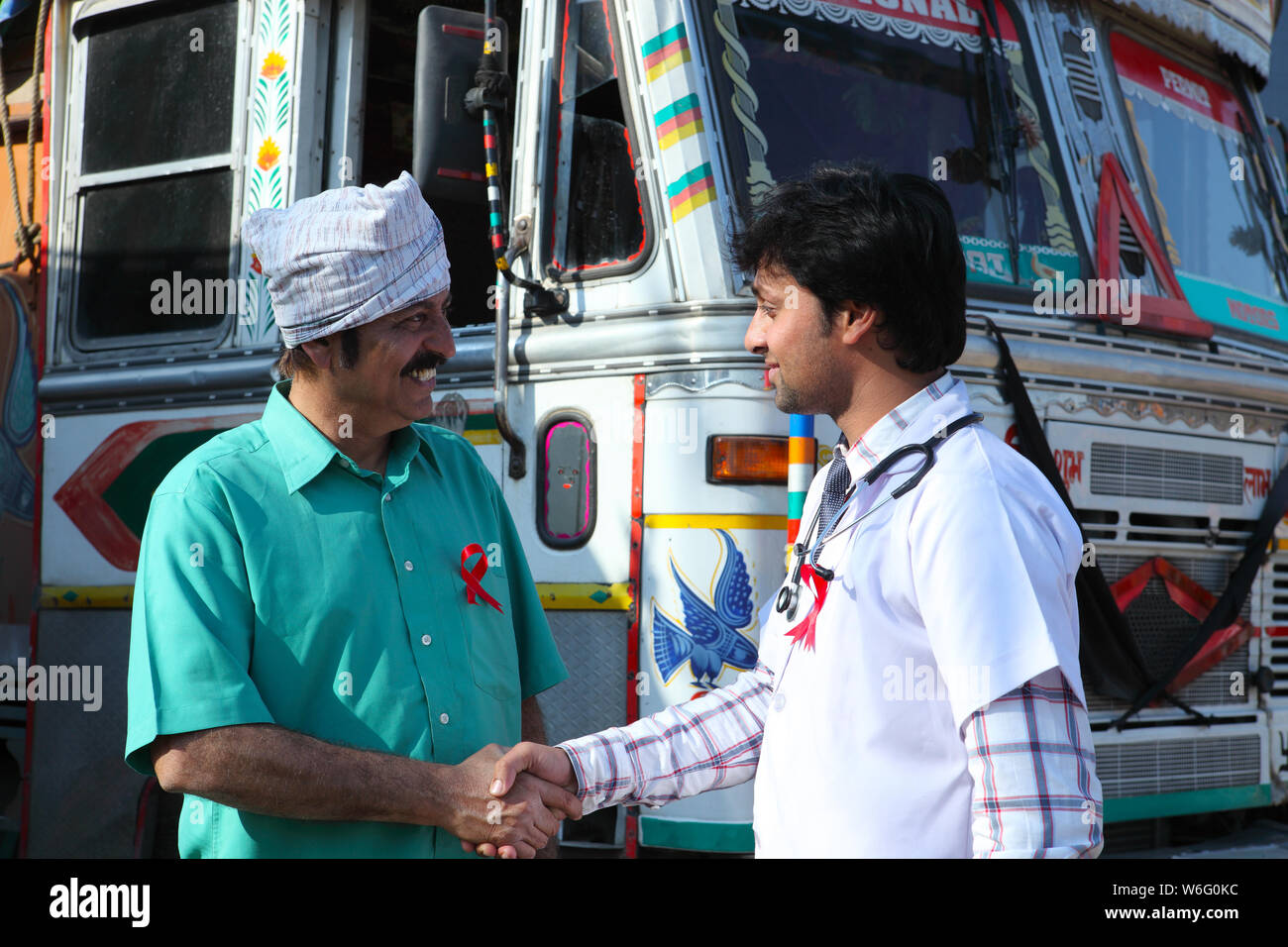 Doctor shaking hands with a truck driver Stock Photo - Alamy