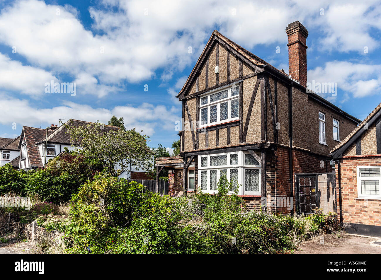 Neglected timber framed house with overgrown front garden, Green Lane ...