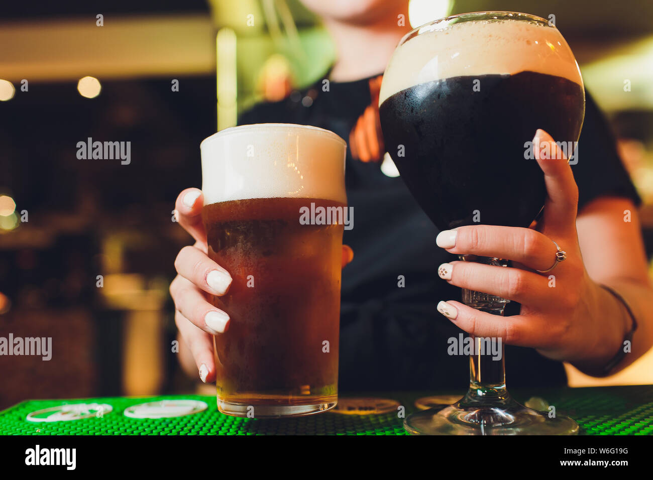 Bartender pours dark beer in hi-res stock photography and images - Alamy
