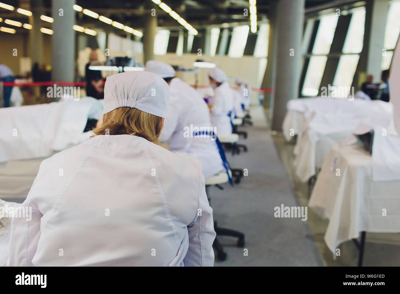 Female Doctor In Surgery Reading Patient Notes Stock Photo - Alamy