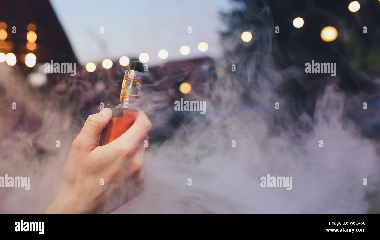 Man is smoking electronic cigarette or vaporizer Stock Photo - Alamy
