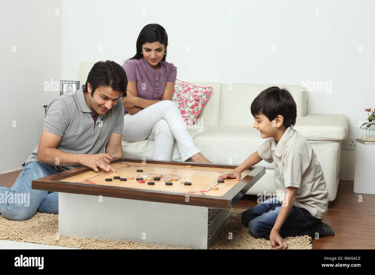 Family playing carrom Stock Photo - Alamy