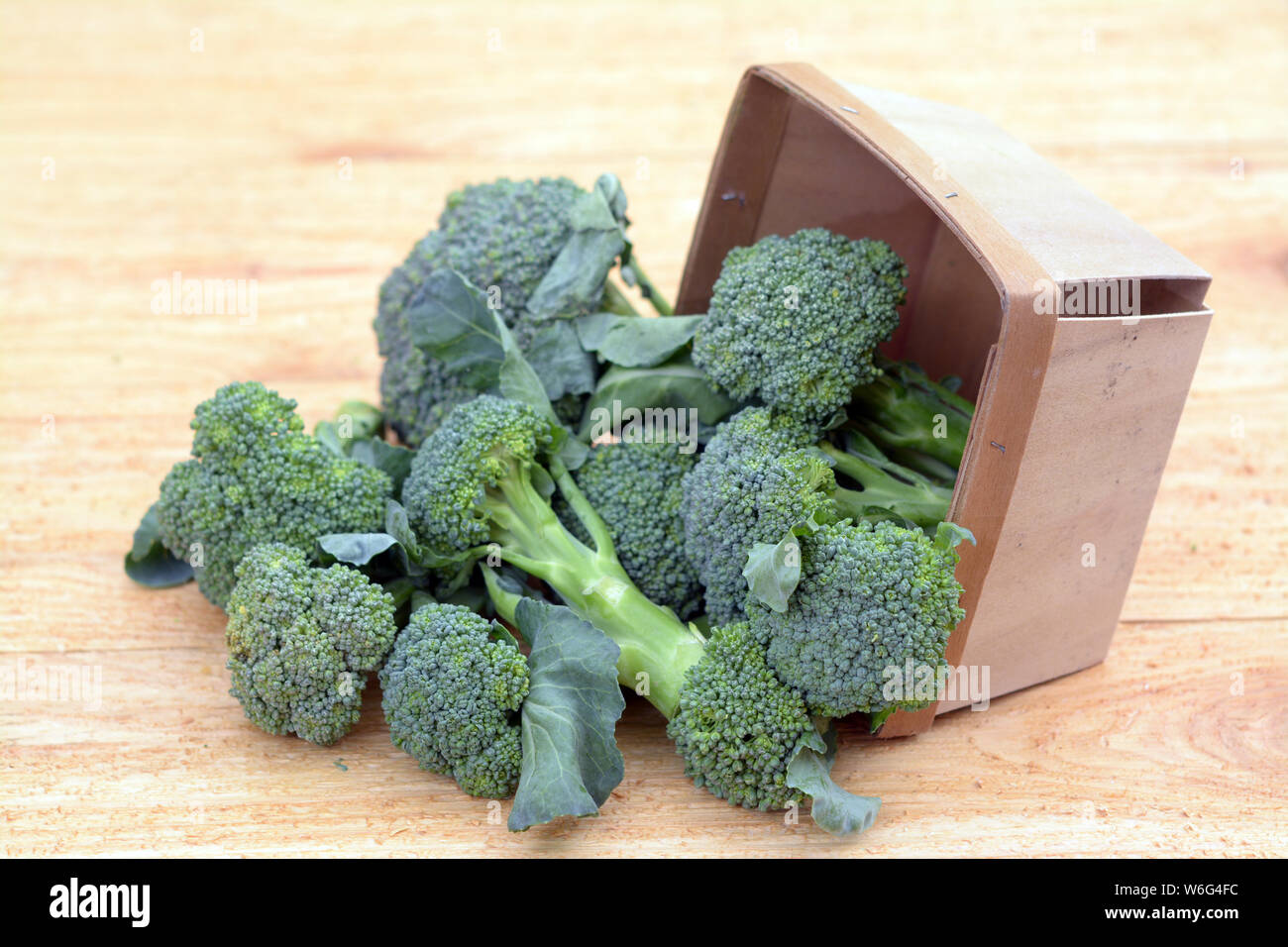 broccoli in crate on wooden table Stock Photo - Alamy
