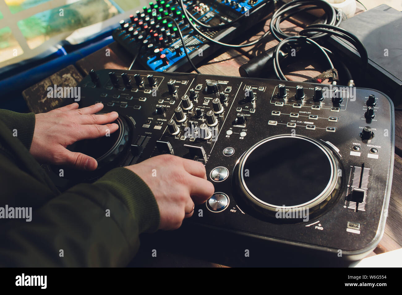 Night club, nightlife concept. Disco. DJ hands mixing the DJ controller ...