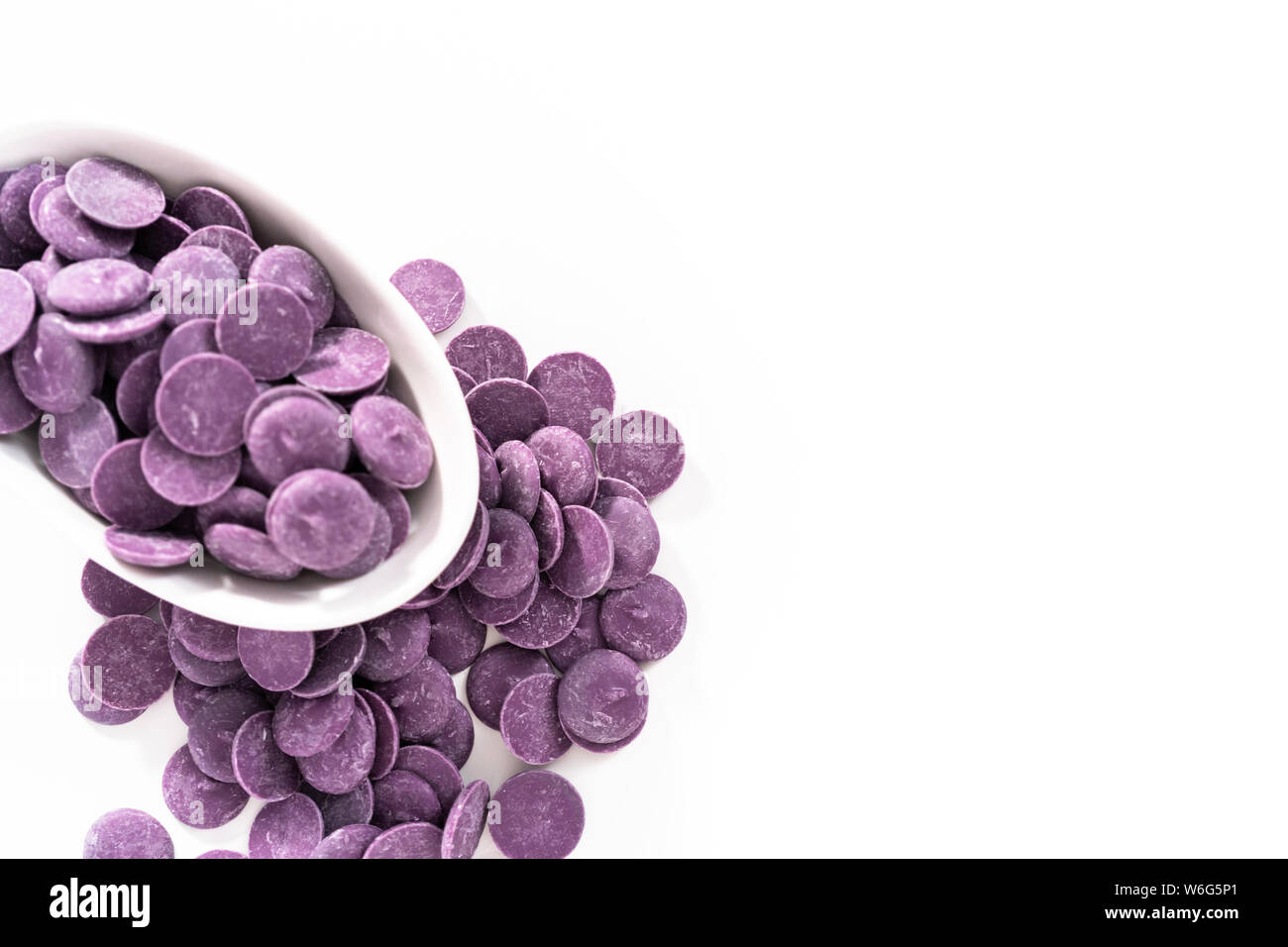 Purple round chocolate chips for melting chocolate shapes on a white ...