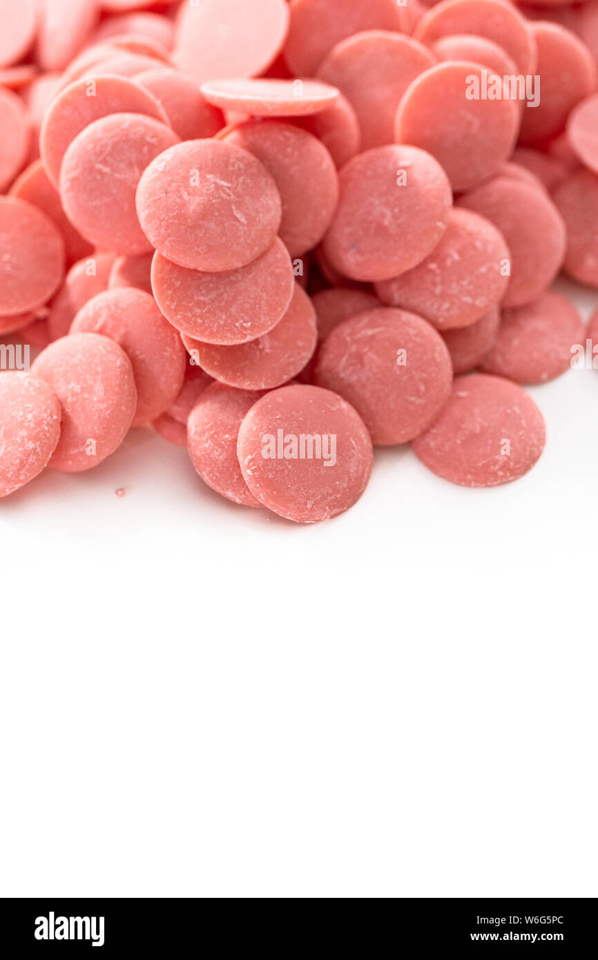 Pink round chocolate chips for melting chocolate shapes on a white ...