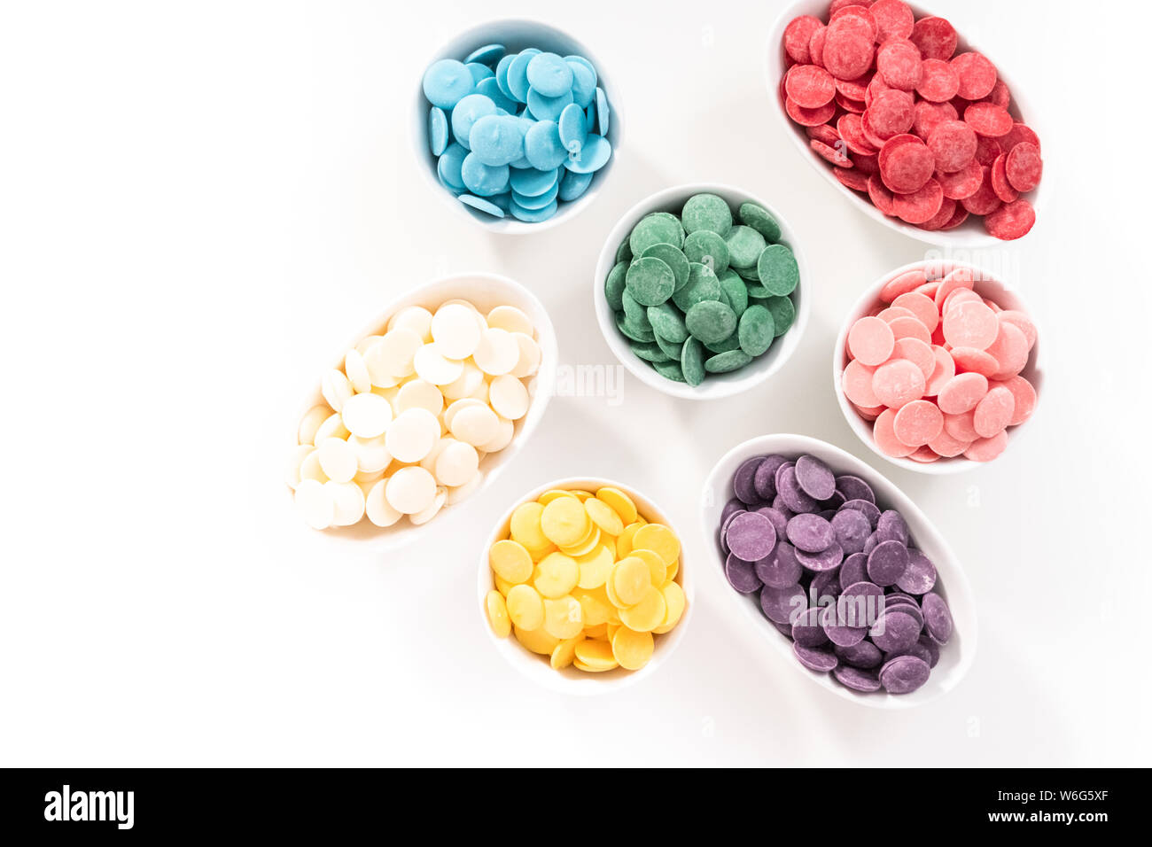 Flat lay. Pink round chocolate chips for melting chocolate shapes on a ...