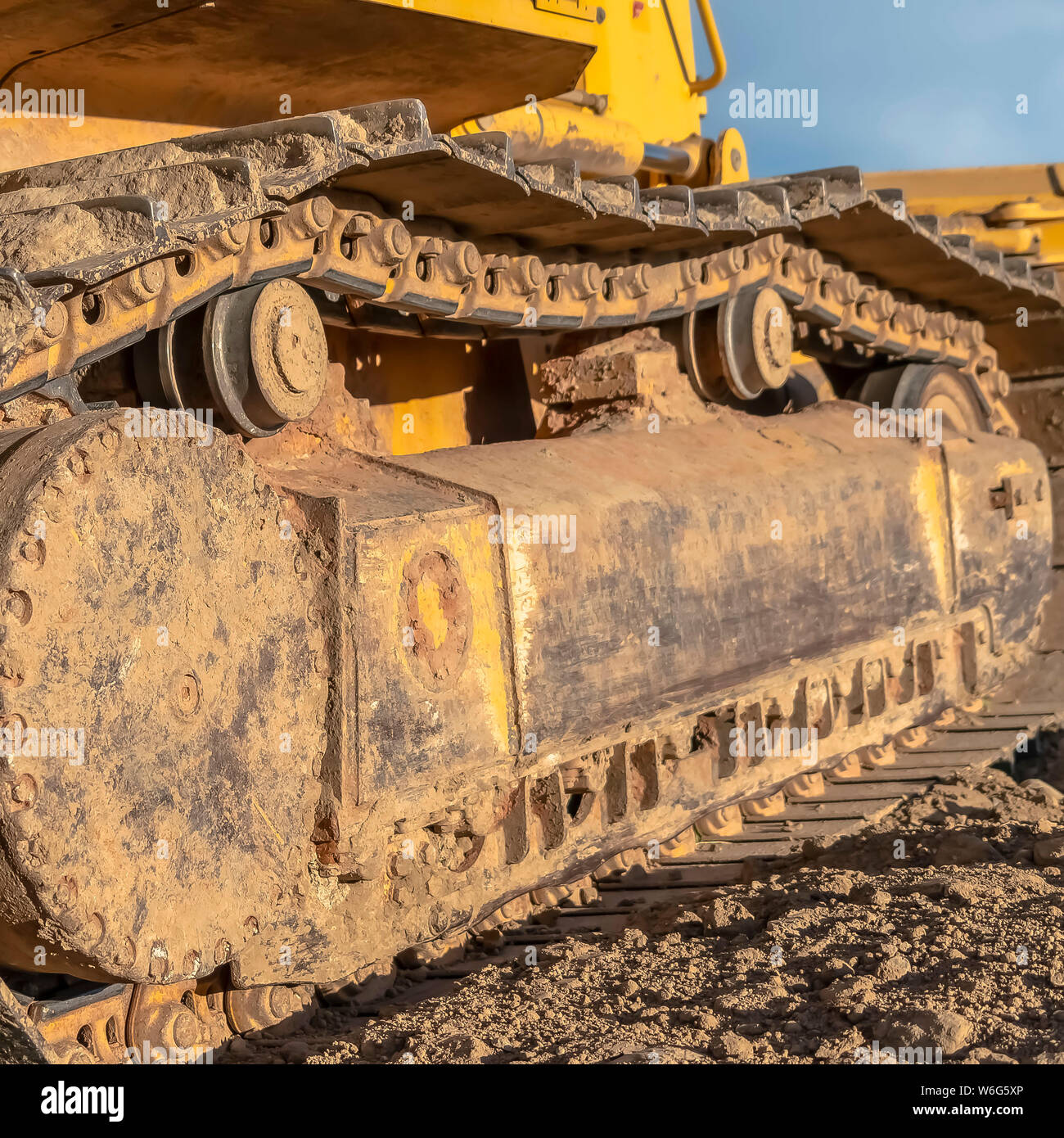 Square frame Yellow excavator with close up view of the grouser pad ...