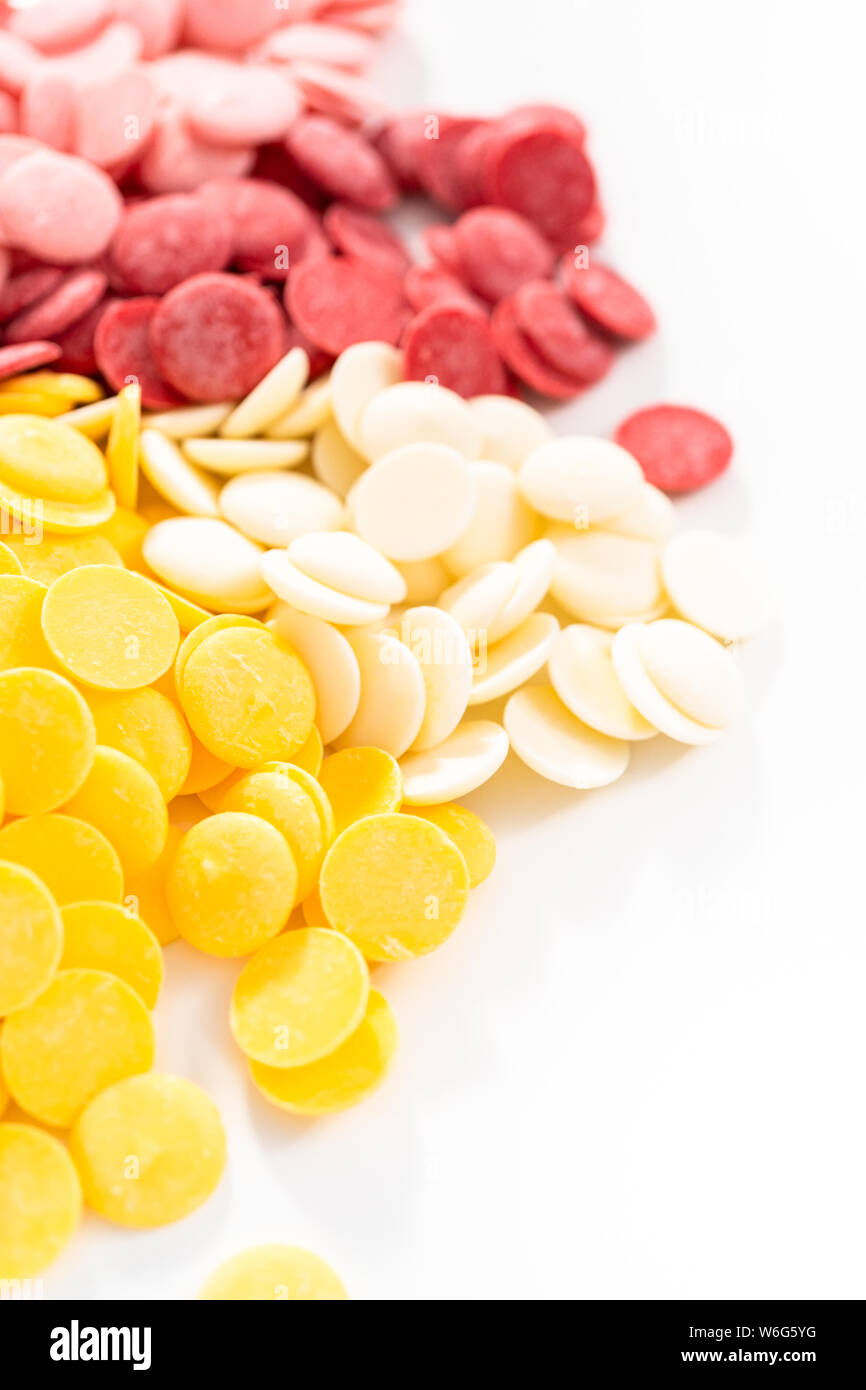 Rainbow colors of round chocolate chips for melting chocolate shapes on ...