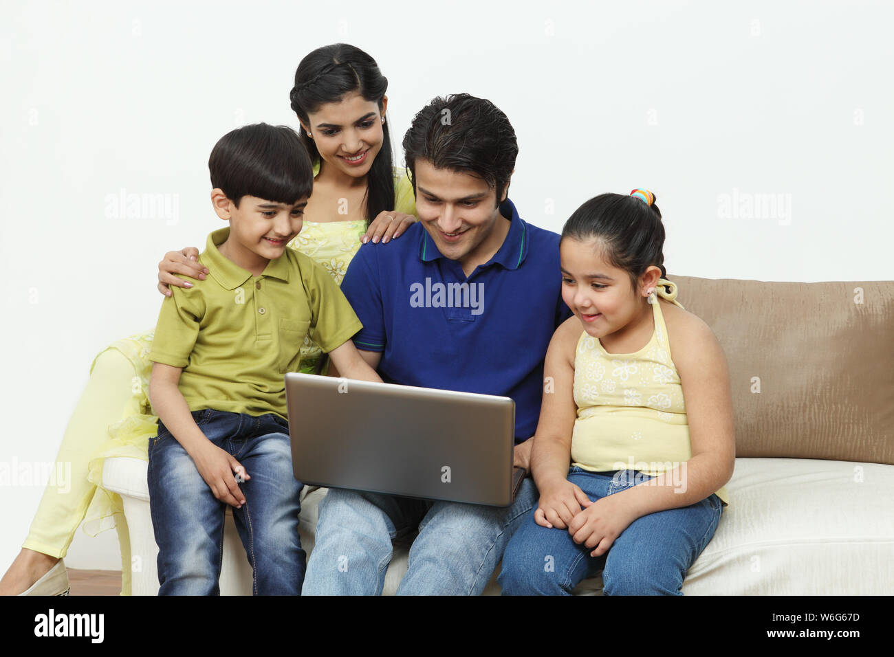 Family using laptop Stock Photo - Alamy
