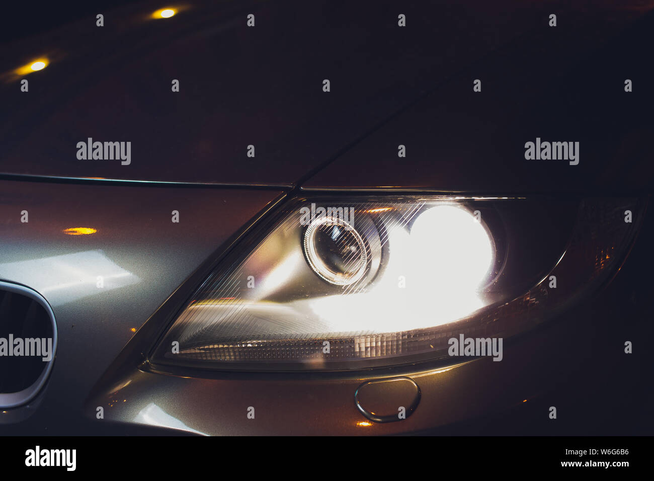 Close up of headlight detail of modern luxury car with projector lens ...