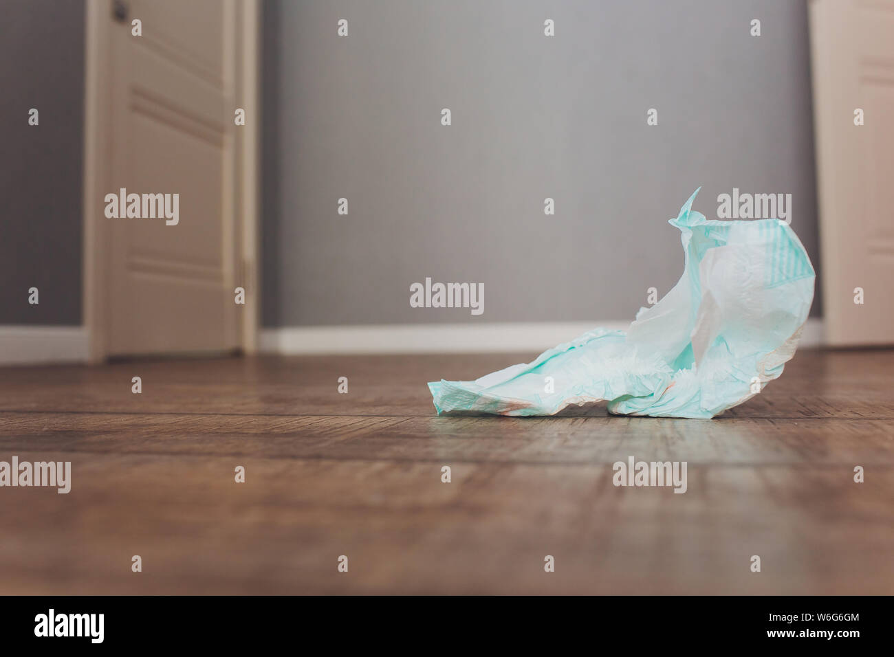 Changing babies diapers some used on the floor Stock Photo - Alamy