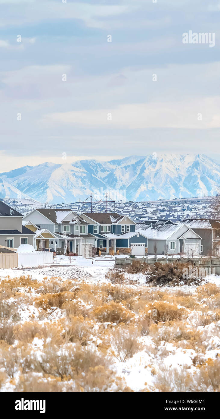 Vertical Houses with snowy roofs and surrounded by snow covered ground ...