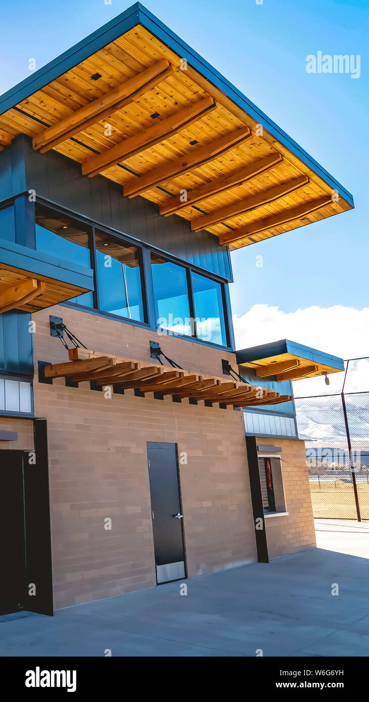 Vertical Park building with flat roof and brick wall under blue sky and ...