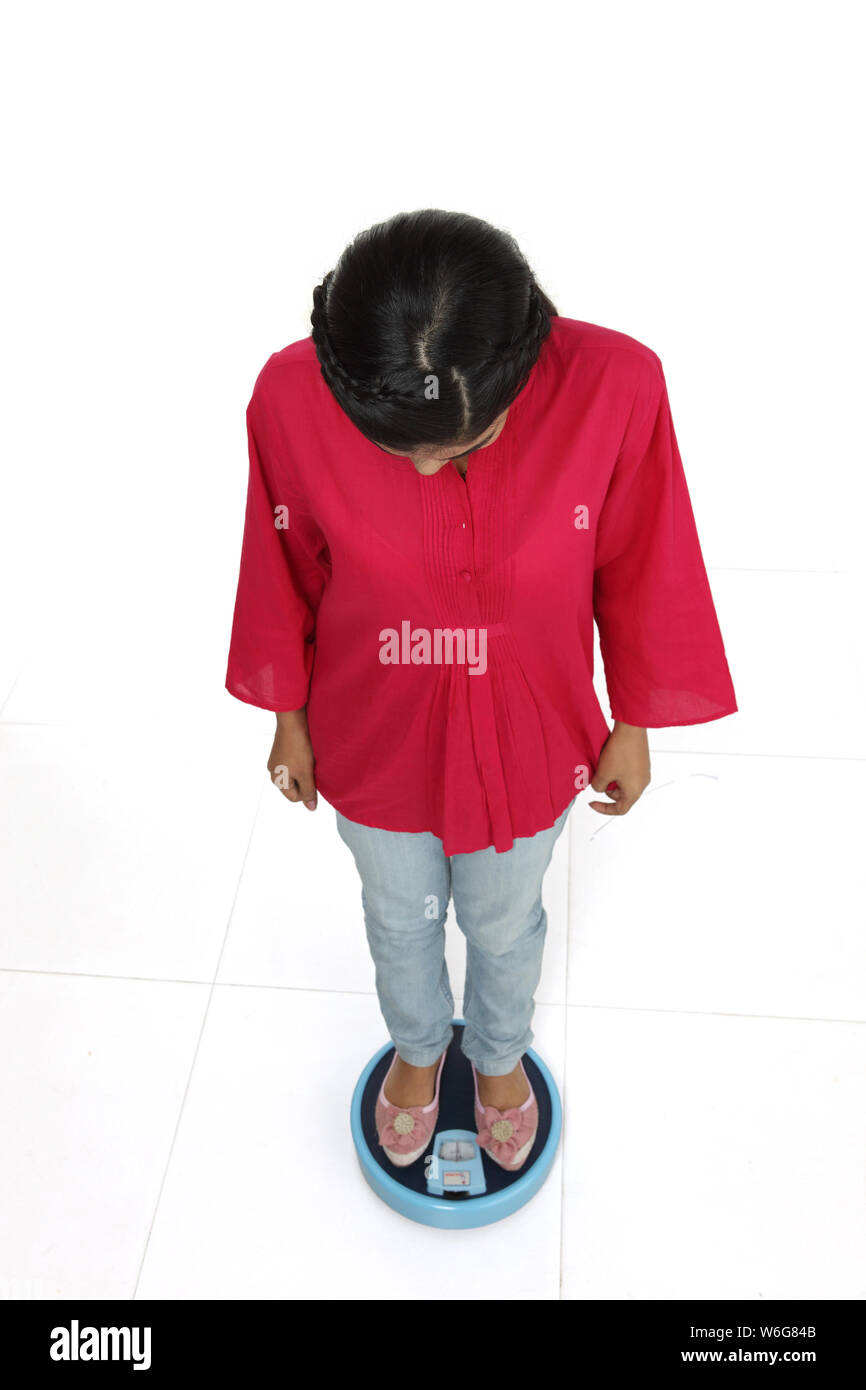 Person standing on scale jeans hi-res stock photography and images - Alamy