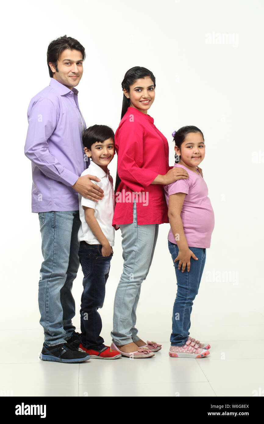 Family standing in a row and smiling Stock Photo - Alamy