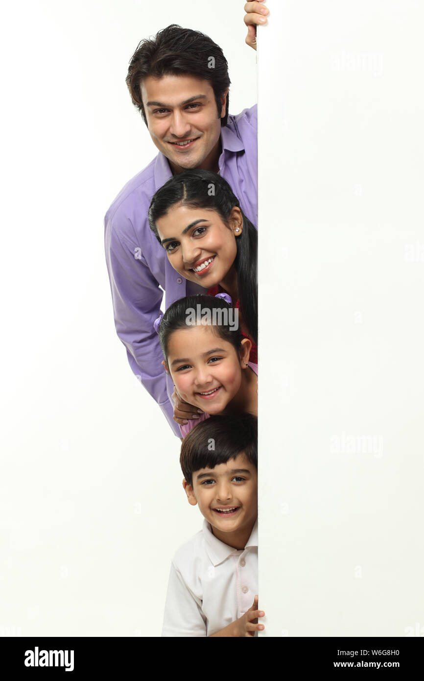 Boy hiding behind mother hi-res stock photography and images - Alamy