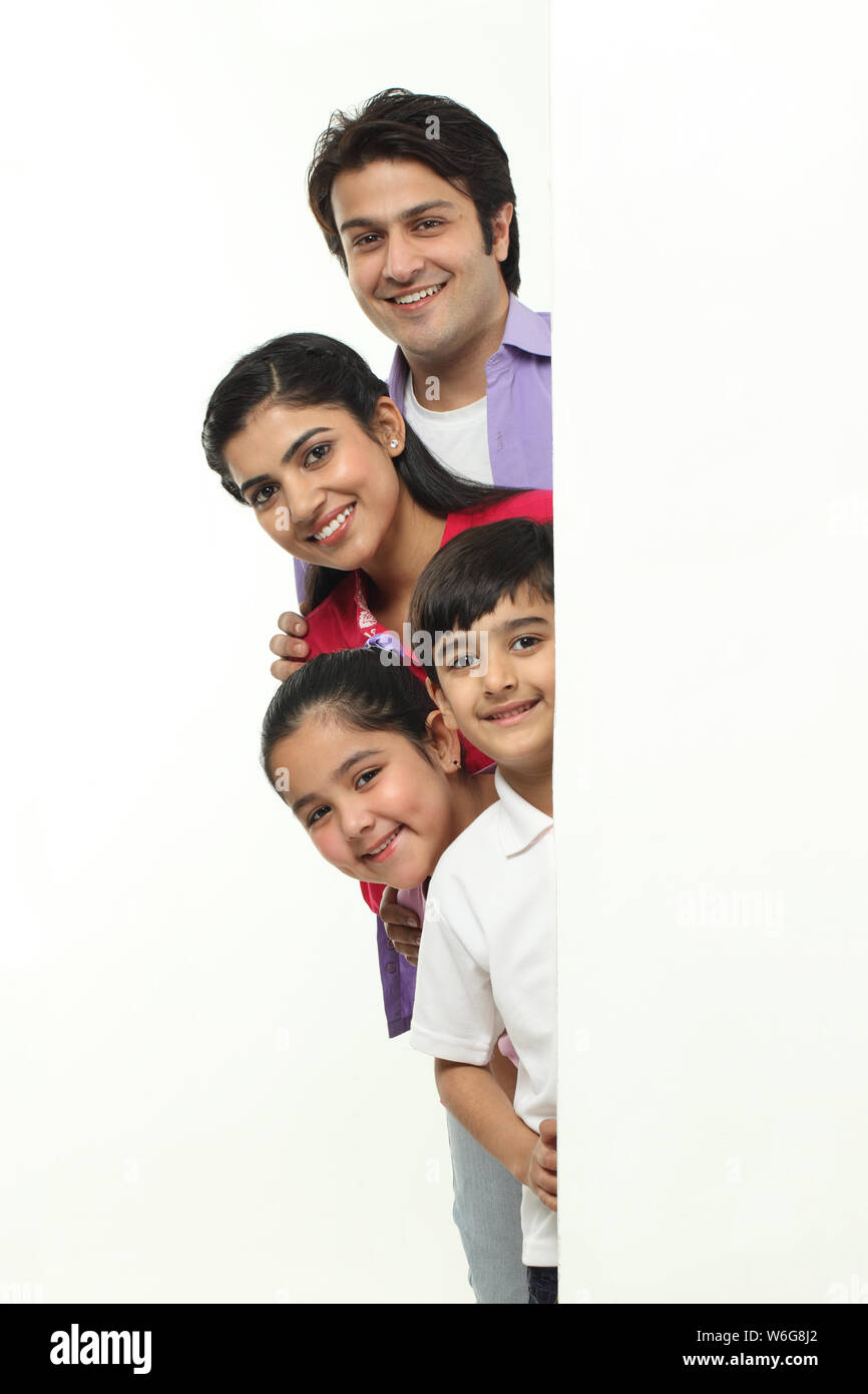 Boy hiding behind mother hi-res stock photography and images - Alamy