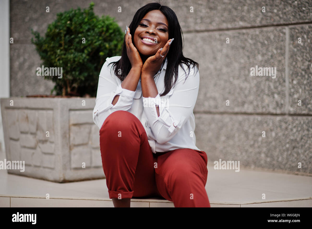 Formally dressed african american business woman in white blouse and ...