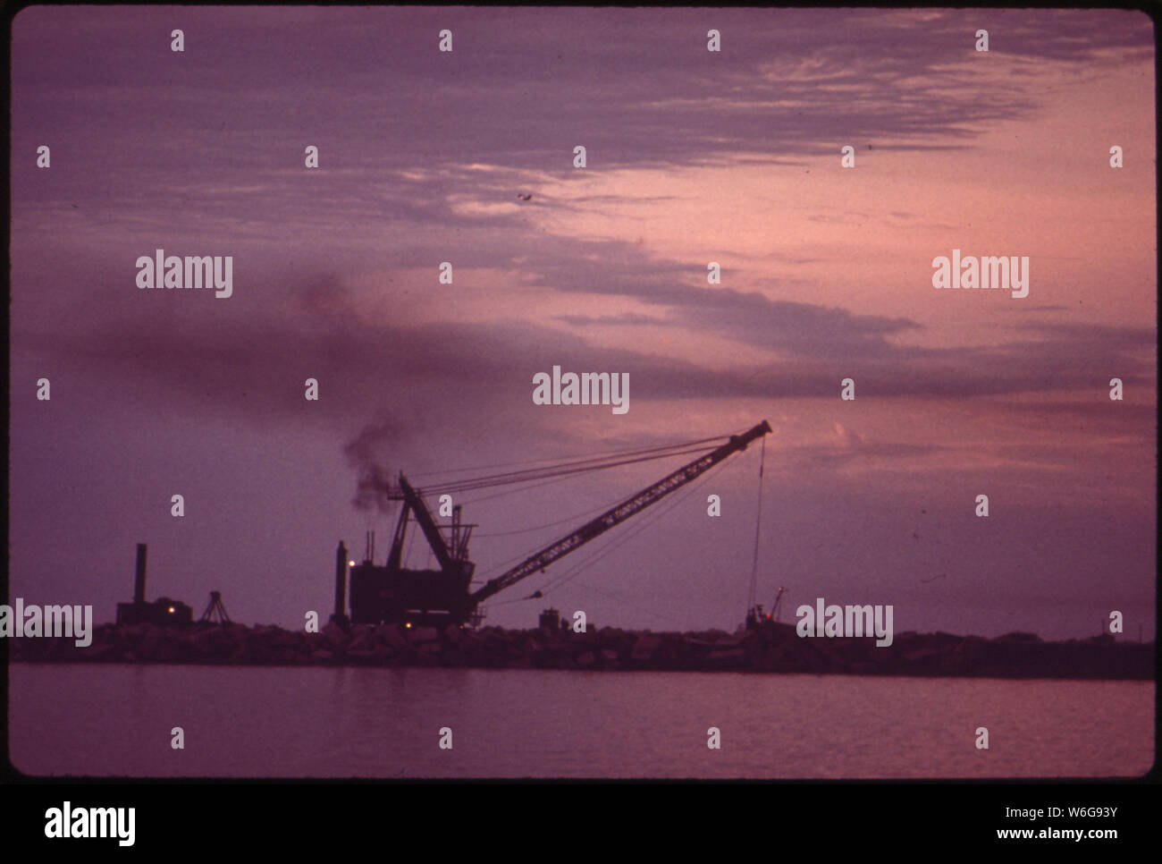 DREDGE BARGE AT WORK INSIDE BREAKWATER OF CONSUMER POWER PLANT AT ...