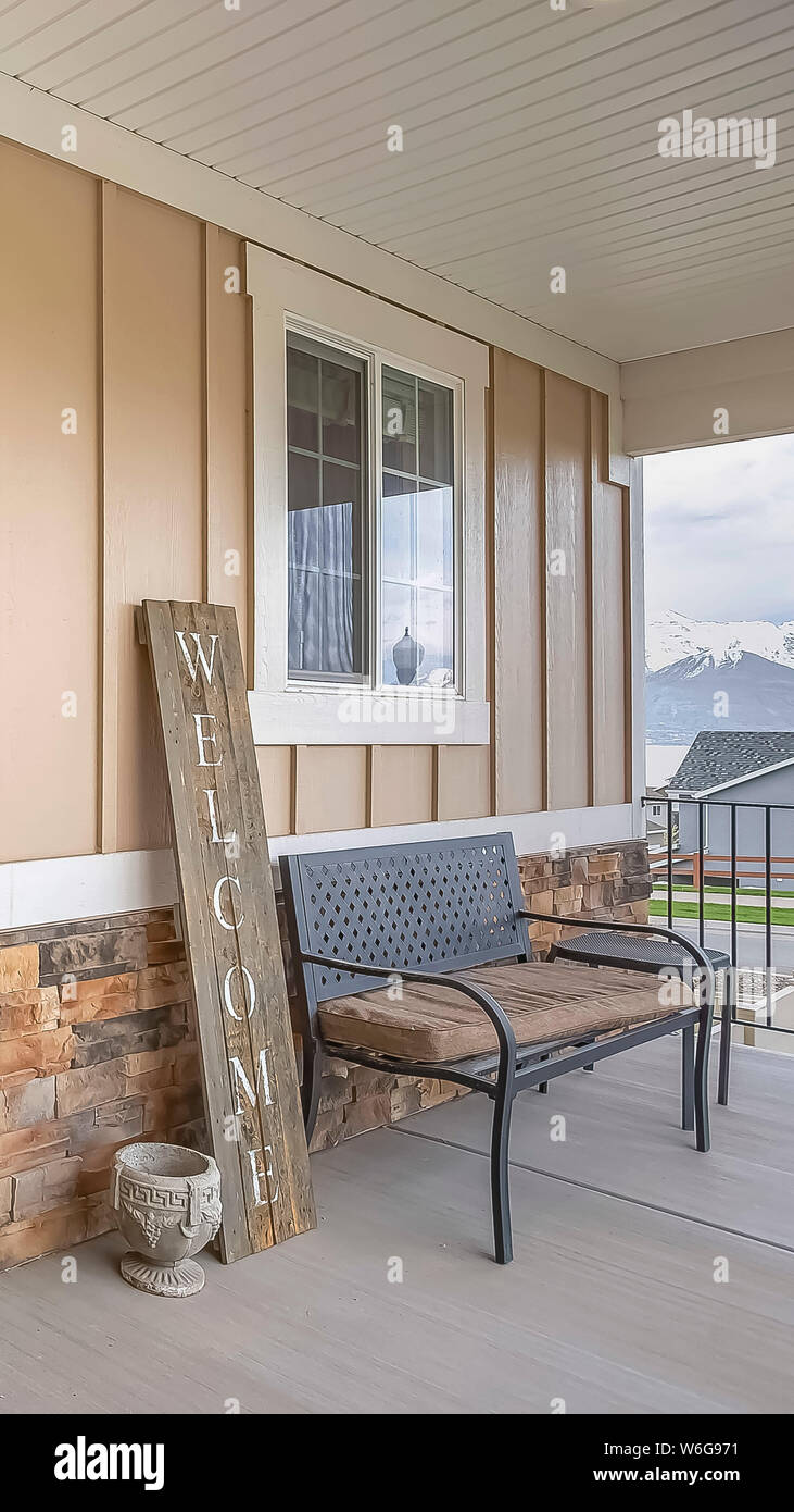 Vertical frame Home facade with a glass paned front door and stone ...