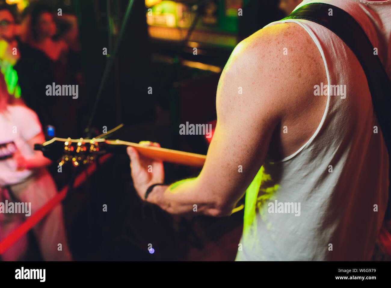 Young boy playing the acoustic guitar inside a hall back view Stock ...