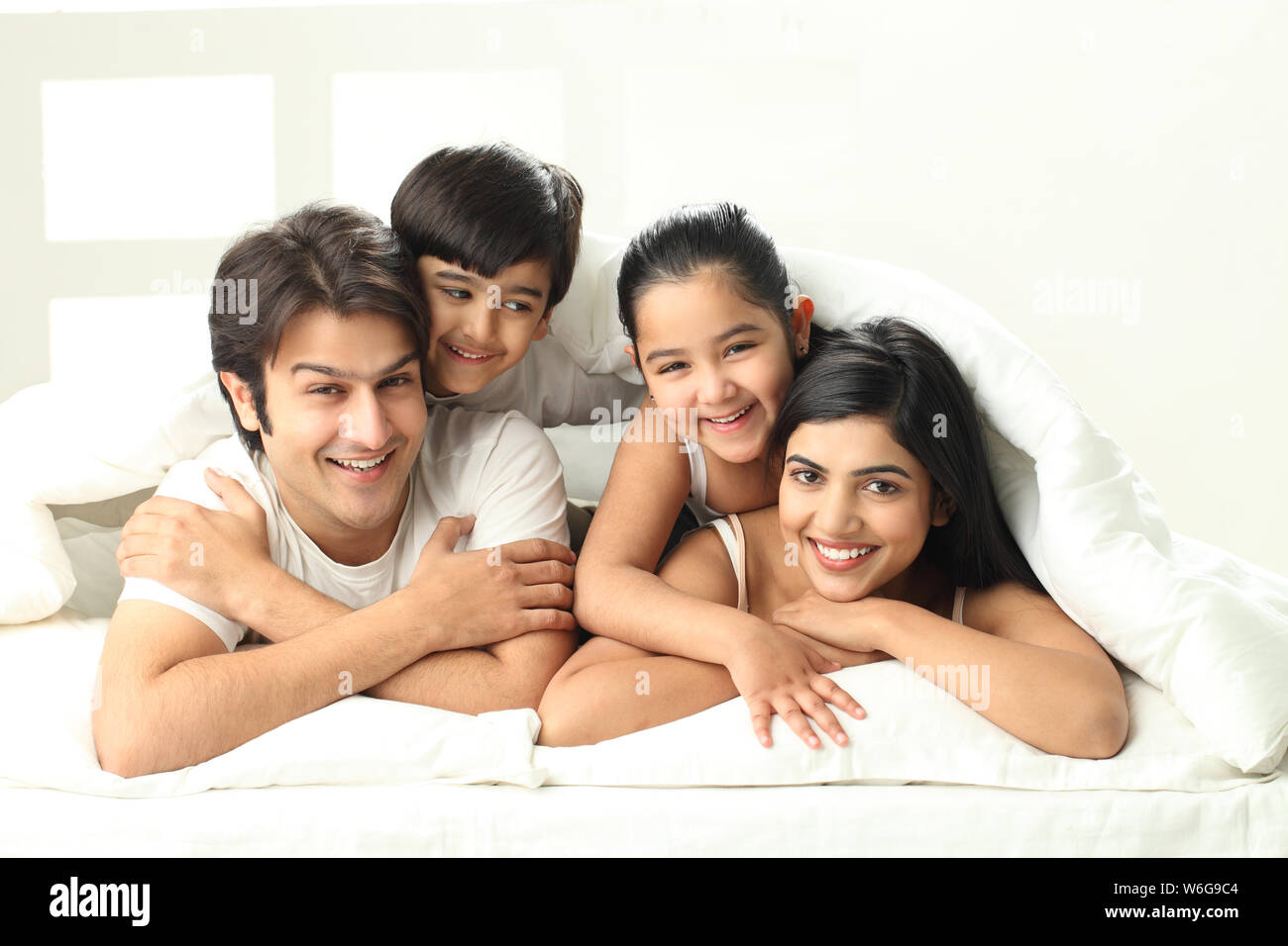 Family on the bed hi-res stock photography and images - Alamy