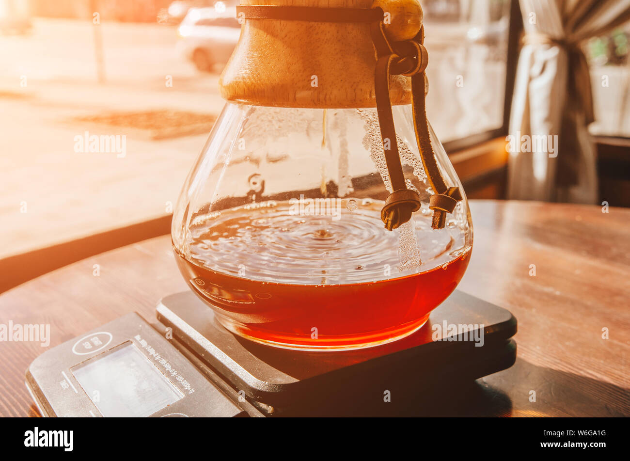 Flask for preparation coffee stands on weights. One of the step of ...