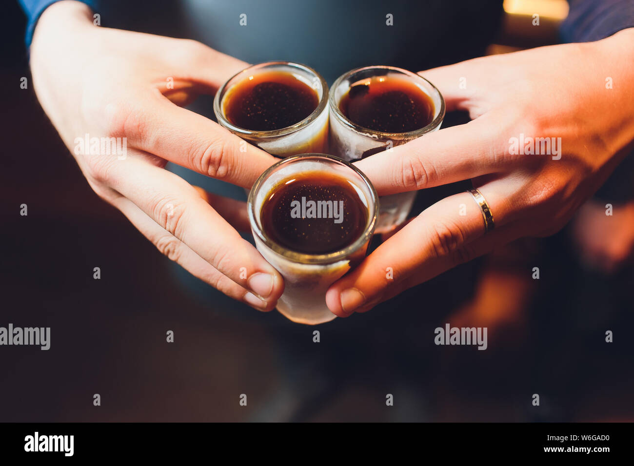 Male Hands Cheer With Glasses Of Shot Or Liqueur Friends Drink Shot Or Liqueur And Cheers Male