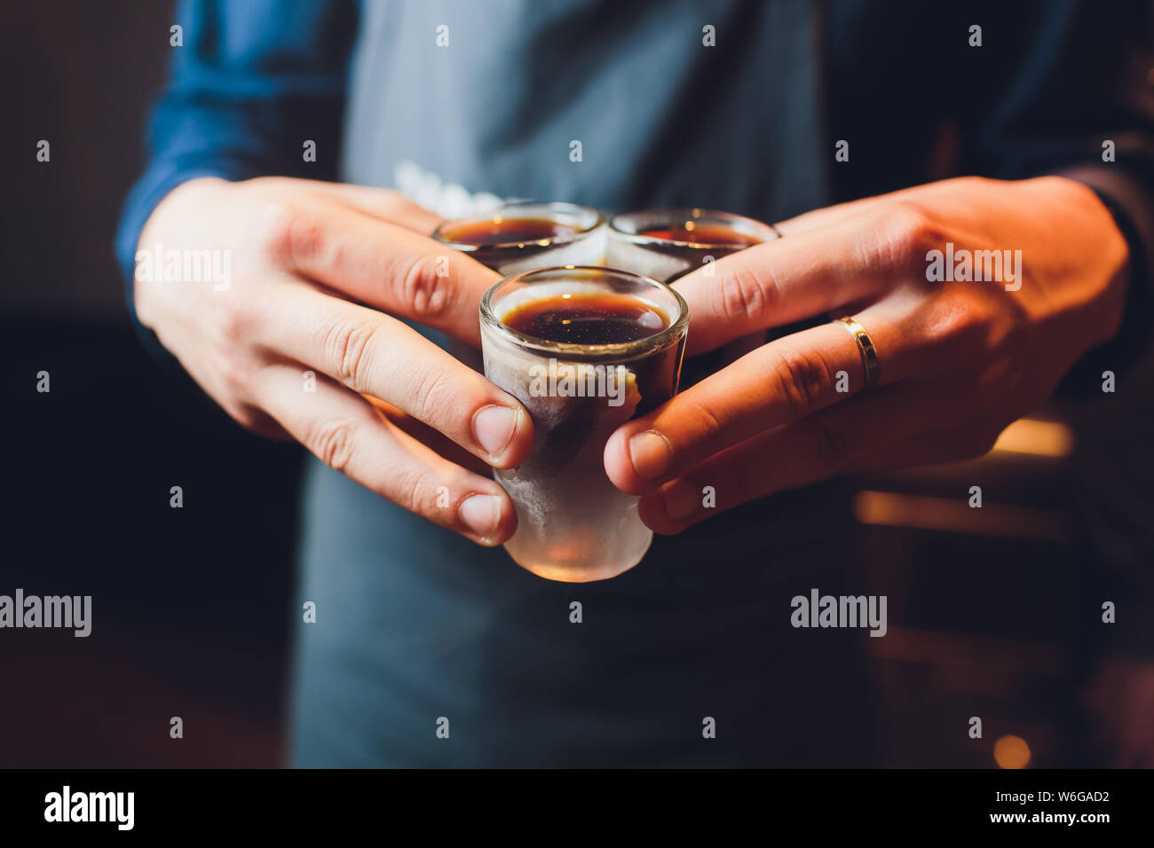 Male Hands Cheer With Glasses Of Shot Or Liqueur Friends Drink Shot Or Liqueur And Cheers Male