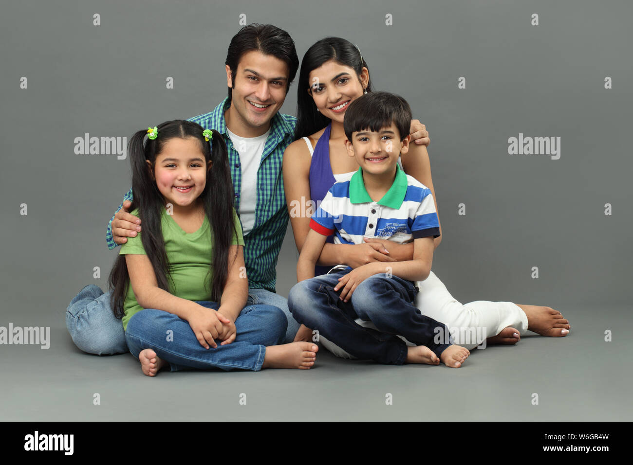 Family sitting together Stock Photo - Alamy