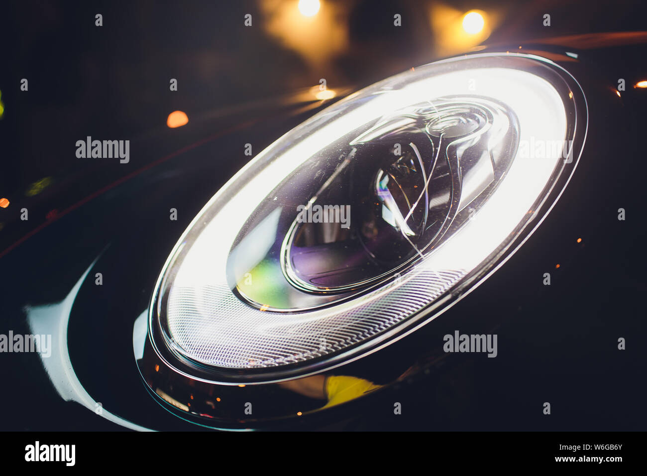 Close up of headlight detail of modern luxury car with projector lens ...