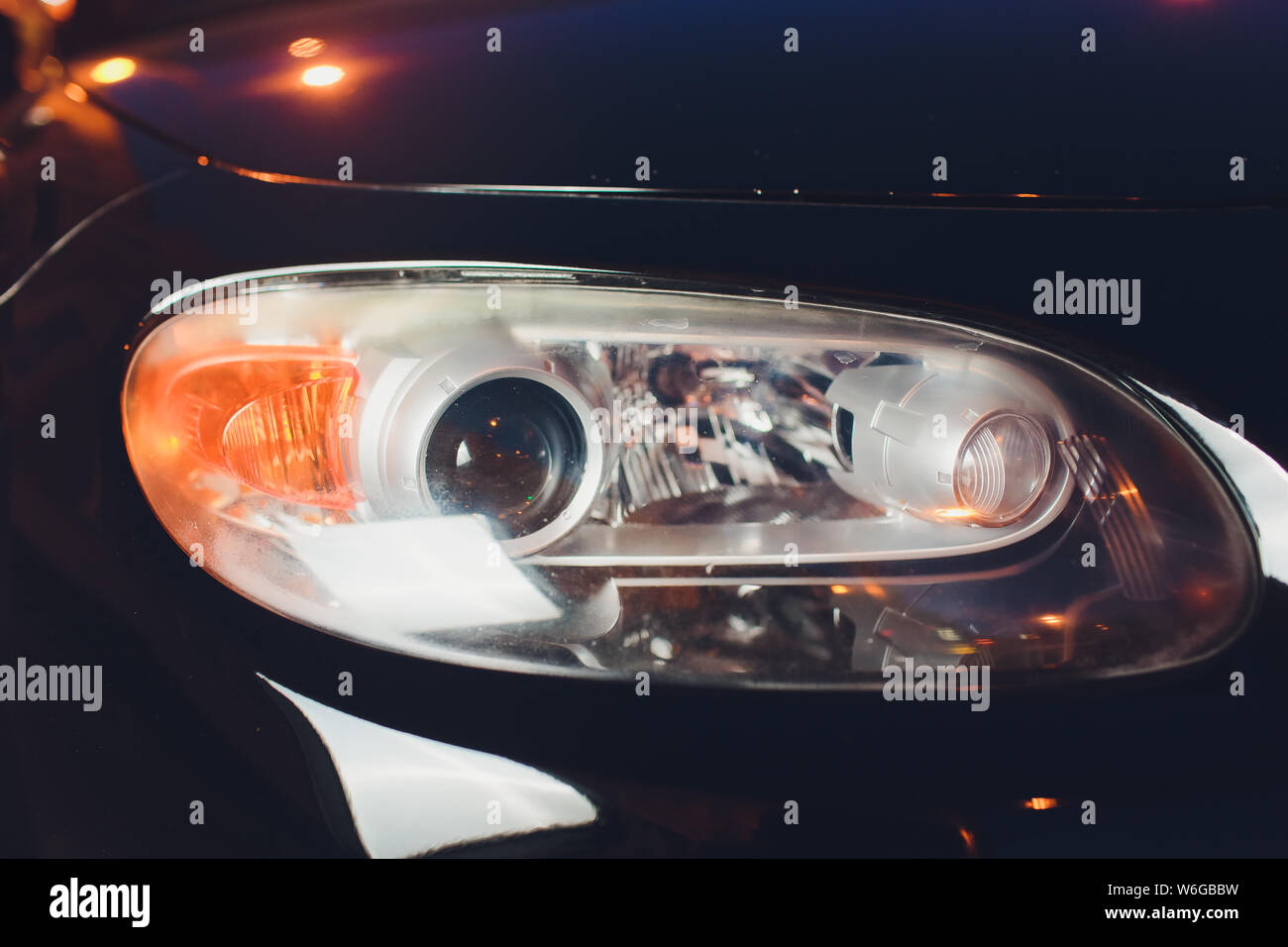 Close up of headlight detail of modern luxury car with projector lens ...