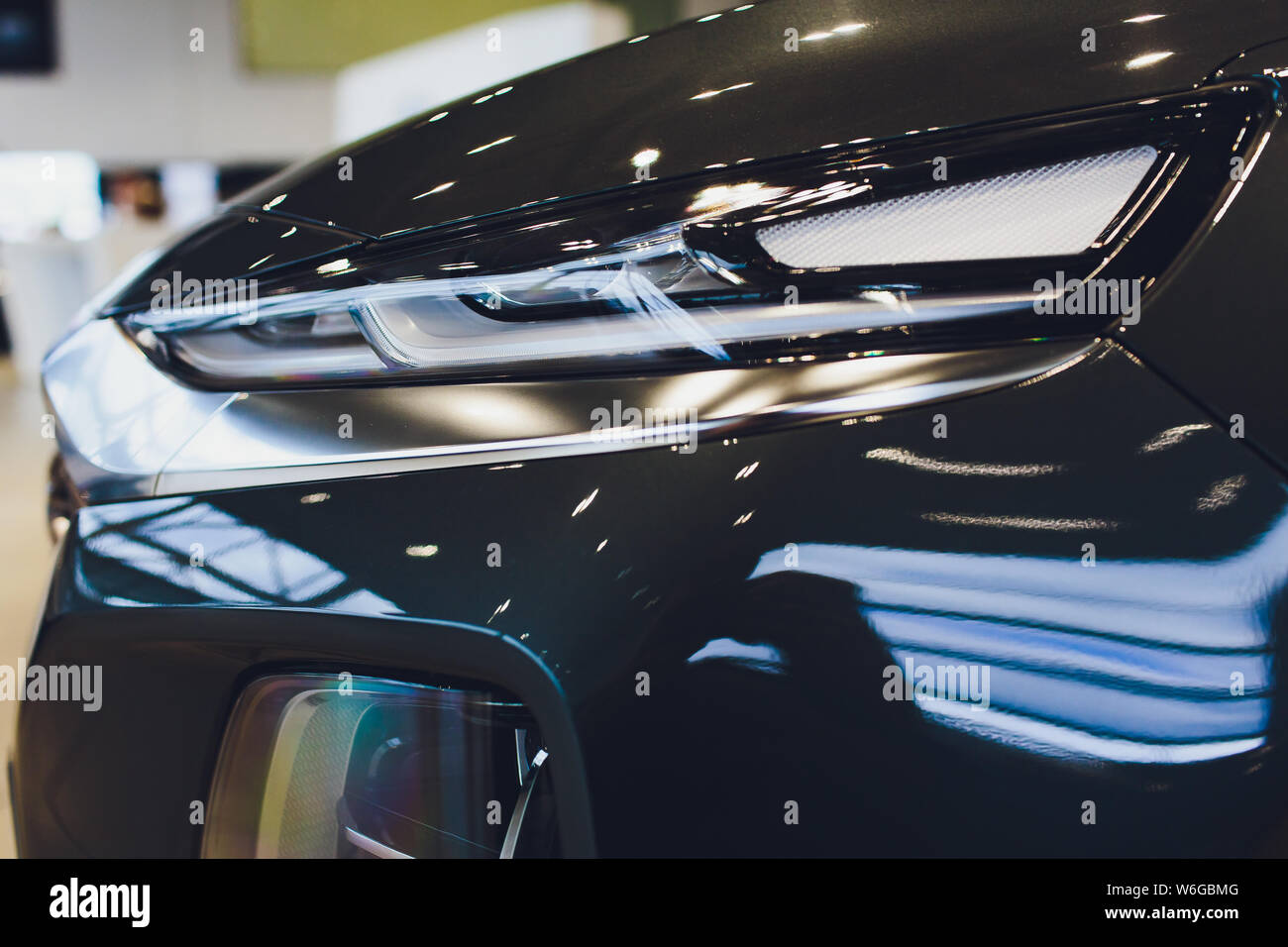 Close up of headlight detail of modern luxury car with projector lens ...