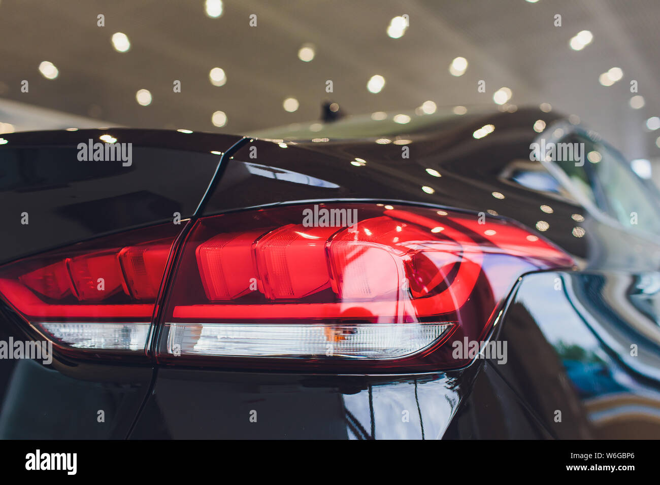 Close up of rear lights detail of modern luxury car with projector lens ...