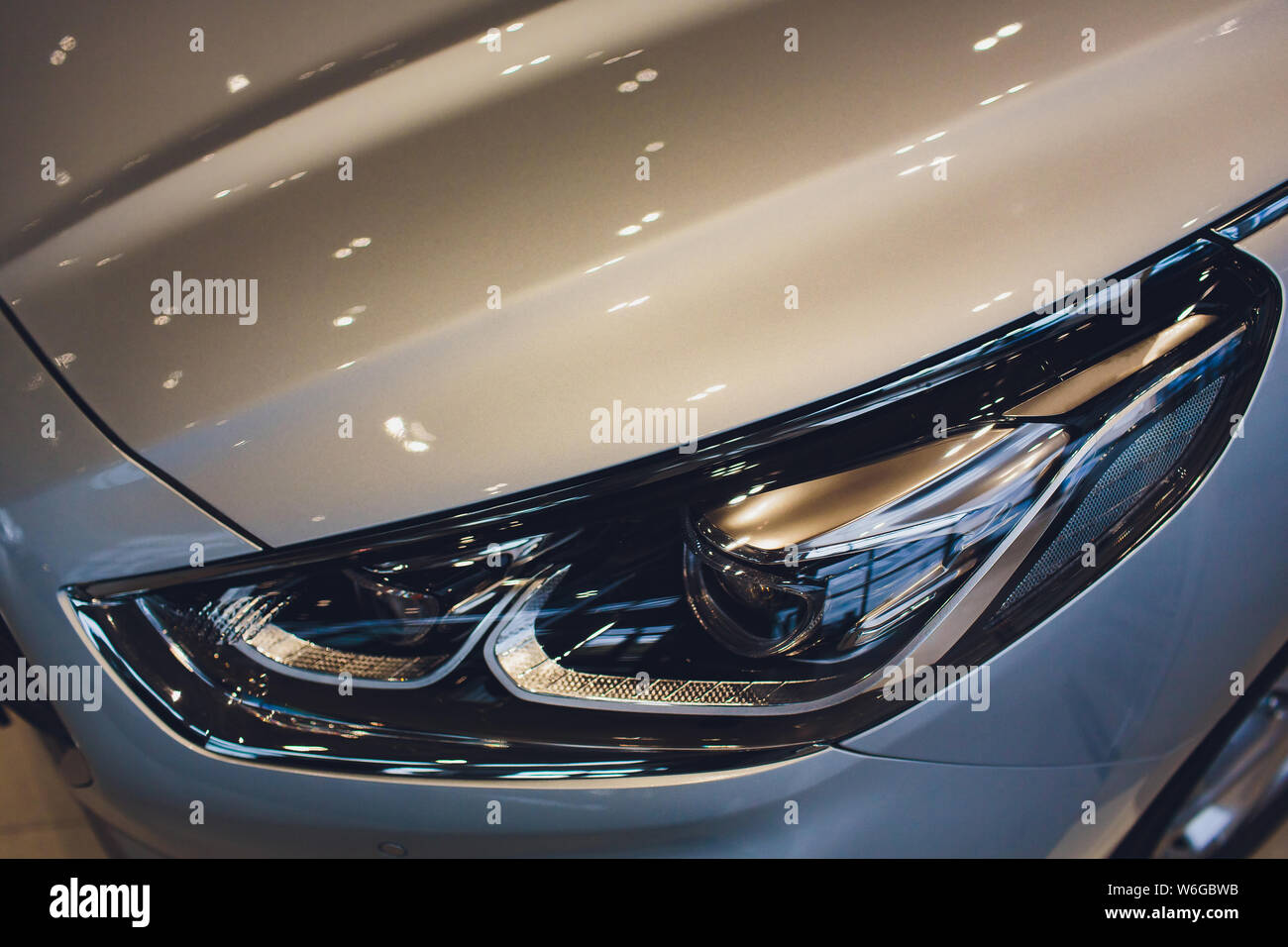 Close up of headlight detail of modern luxury car with projector lens ...