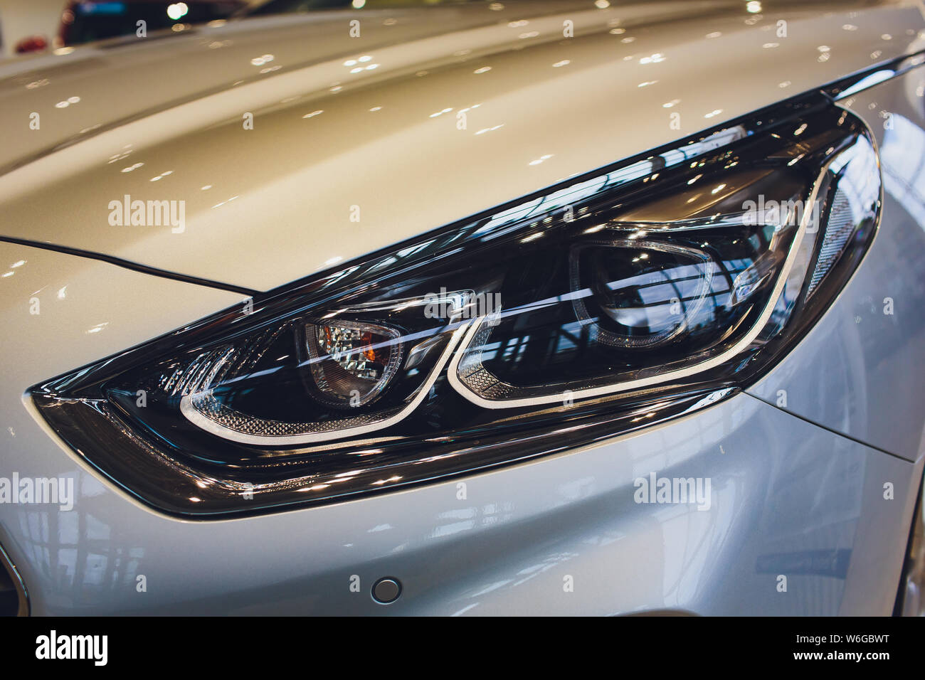 Close up of headlight detail of modern luxury car with projector lens ...