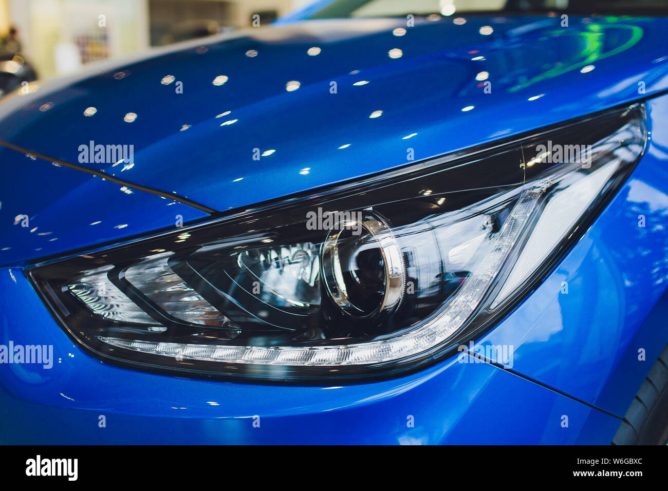 Close up of headlight detail of modern luxury car with projector lens ...