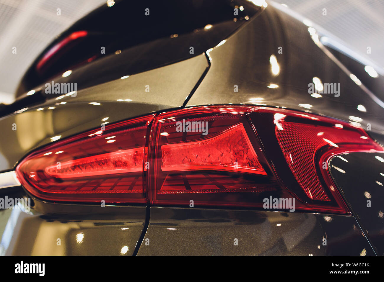 Close up of rear lights detail of modern luxury car with projector lens ...