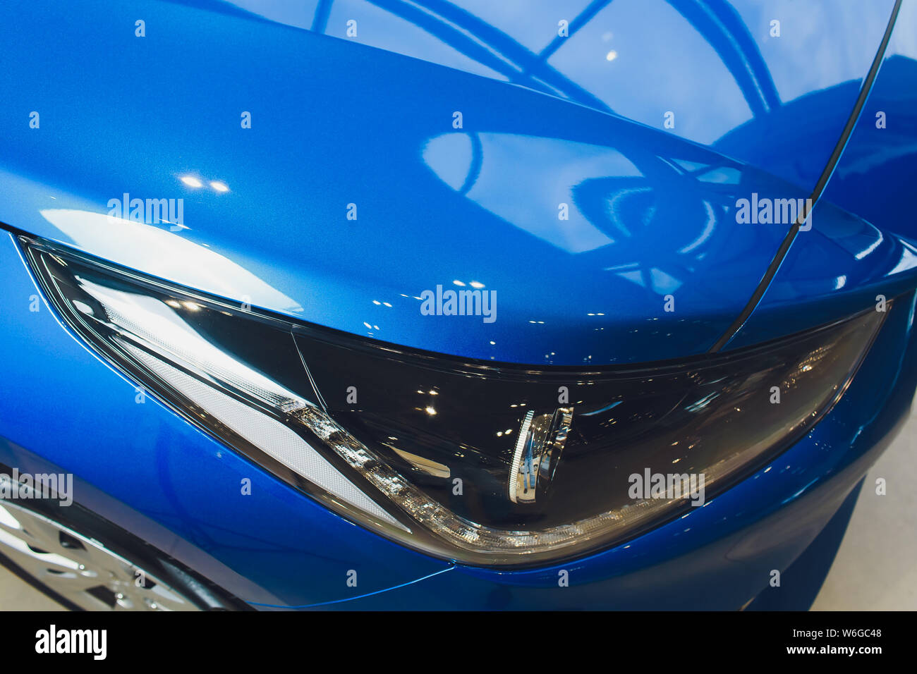 Close up of headlight detail of modern luxury car with projector lens ...