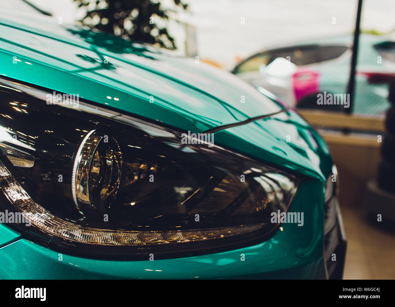 Close up of headlight detail of modern luxury car with projector lens ...