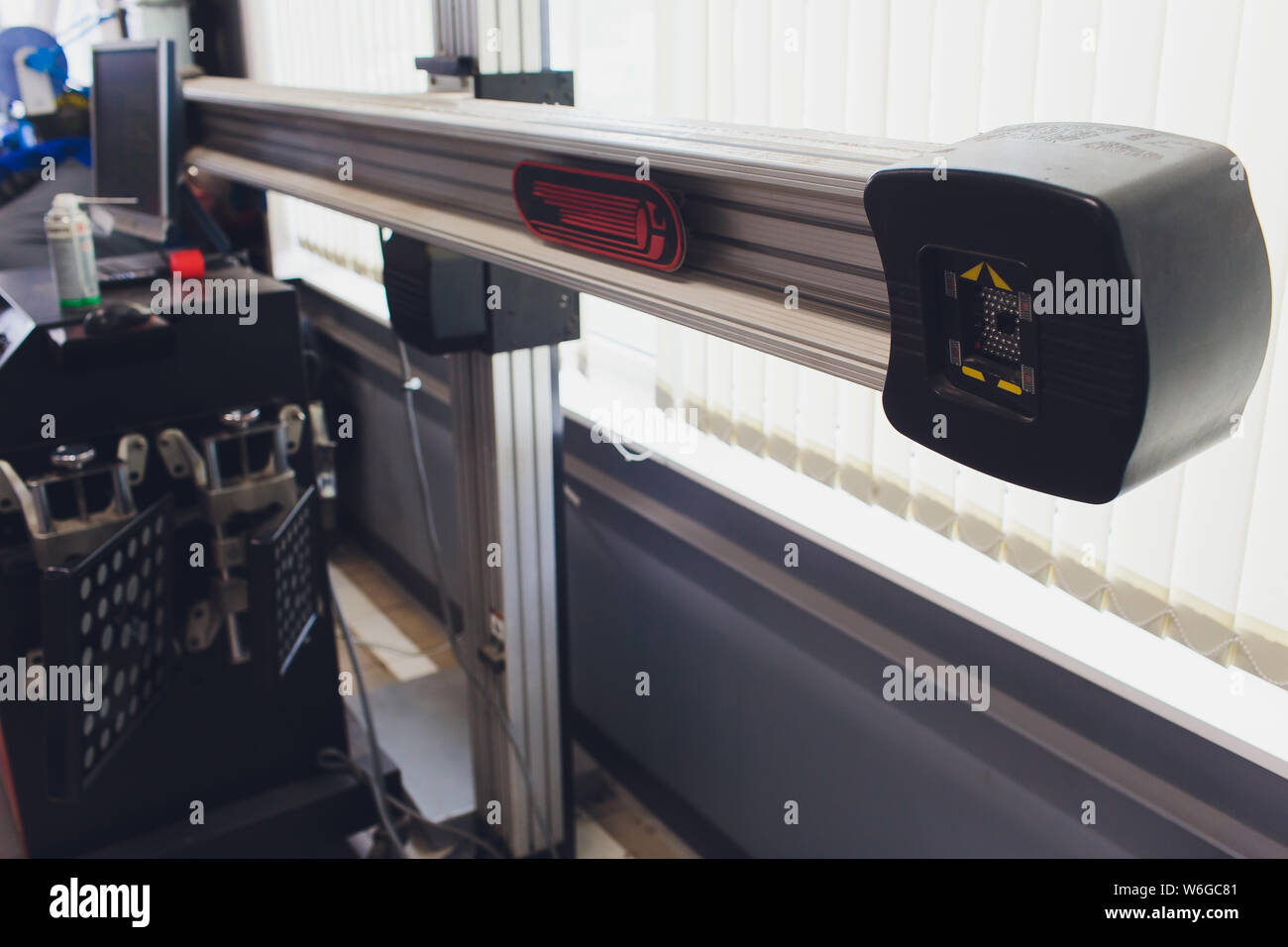 Computerized alignment car tire machine clamp. laser Stock Photo - Alamy