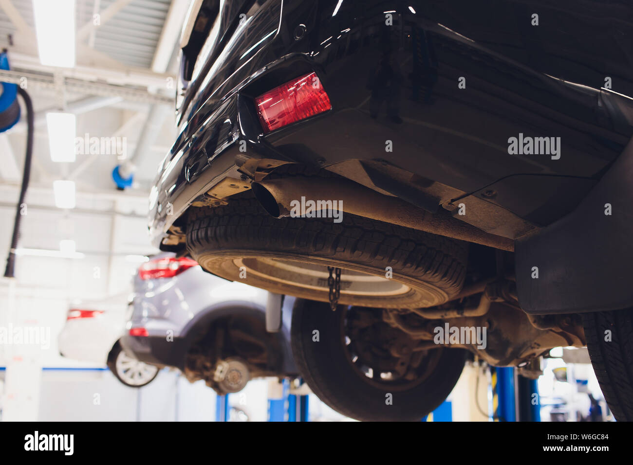 Car raised on car lift in autoservice Stock Photo - Alamy