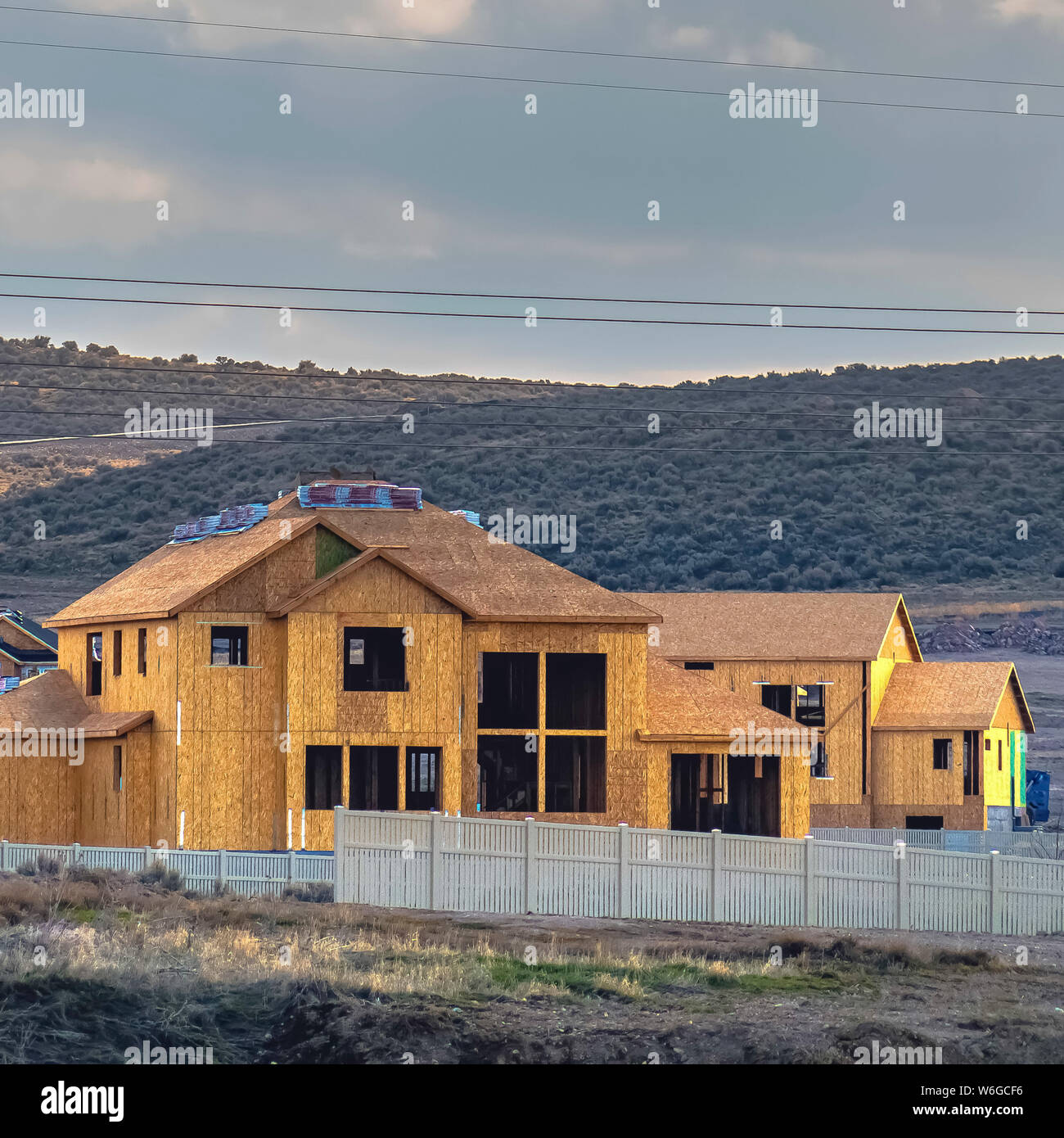 Square Houses under construction with overcast blue sky overhead Stock ...